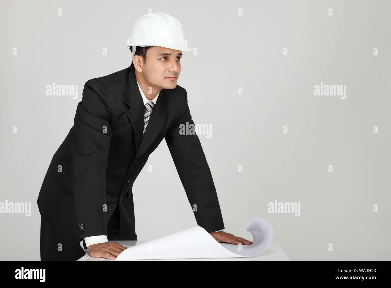 Architect holding a blueprint Stock Photo - Alamy