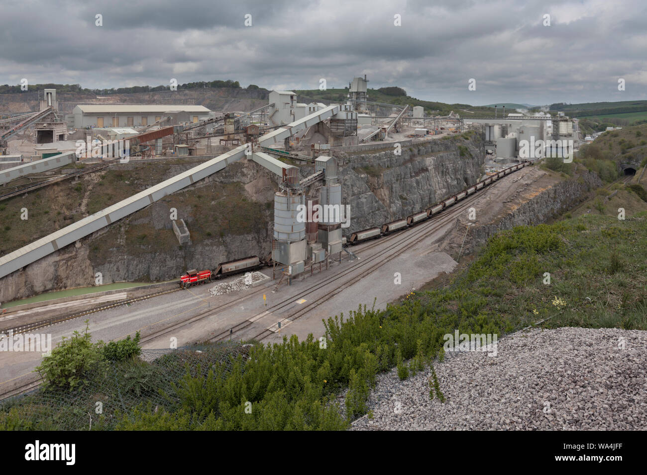 Tunstead quarry Derbyshire. A Hunslet industrial shunter taking hoppers ...