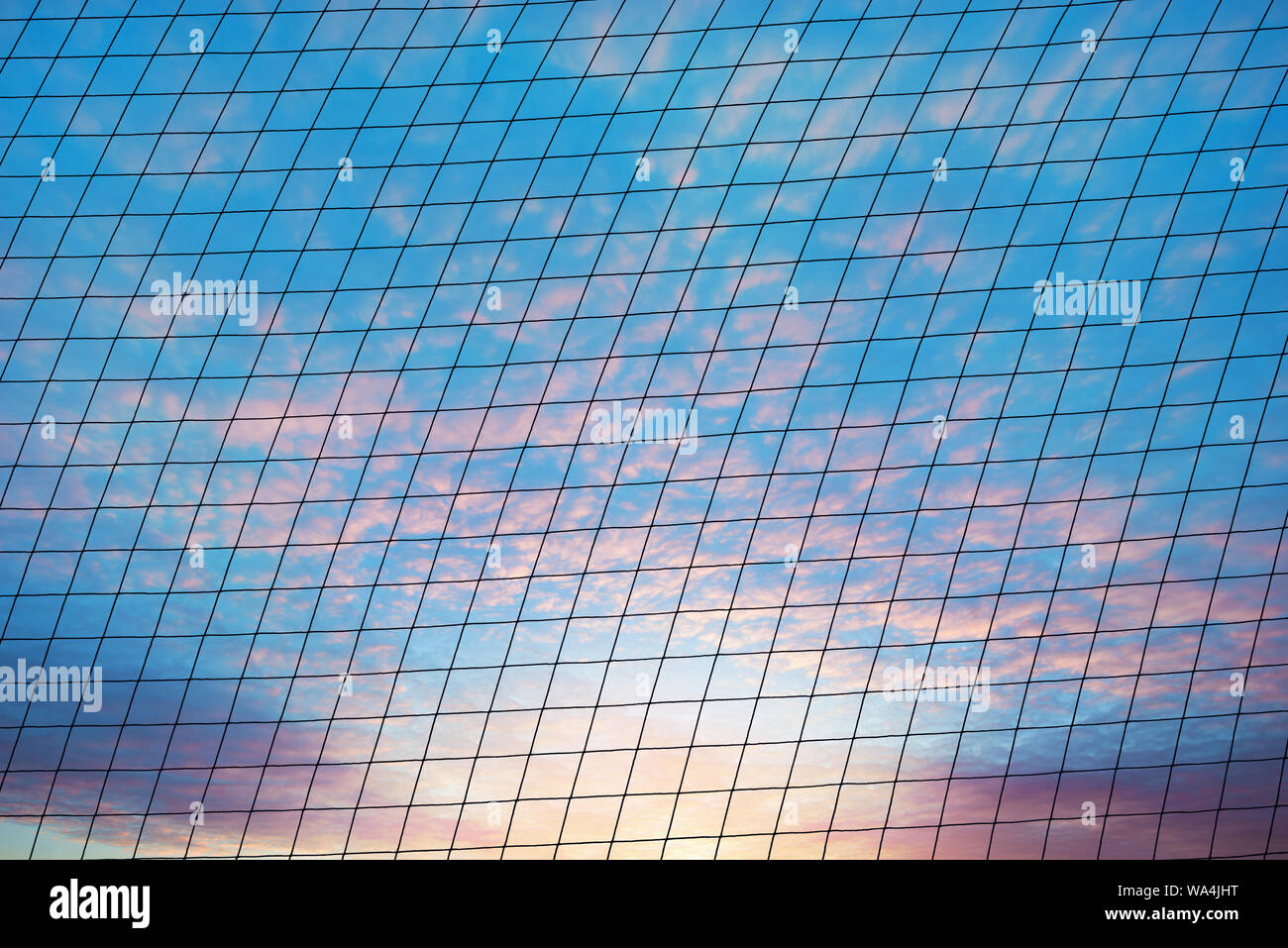 Soccer gate net on sunset sky background Stock Photo - Alamy