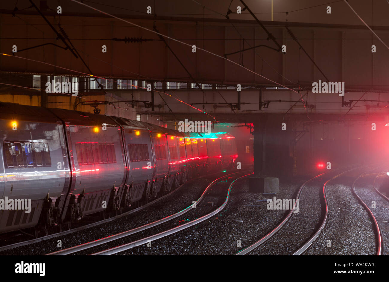 Virgin Trains class 390 pendolino train waiting at a dark misty ...