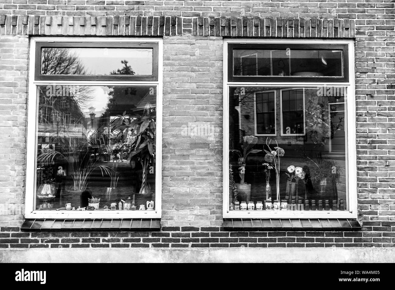 Reflection in old fashioned traditional window and brick wall in ...