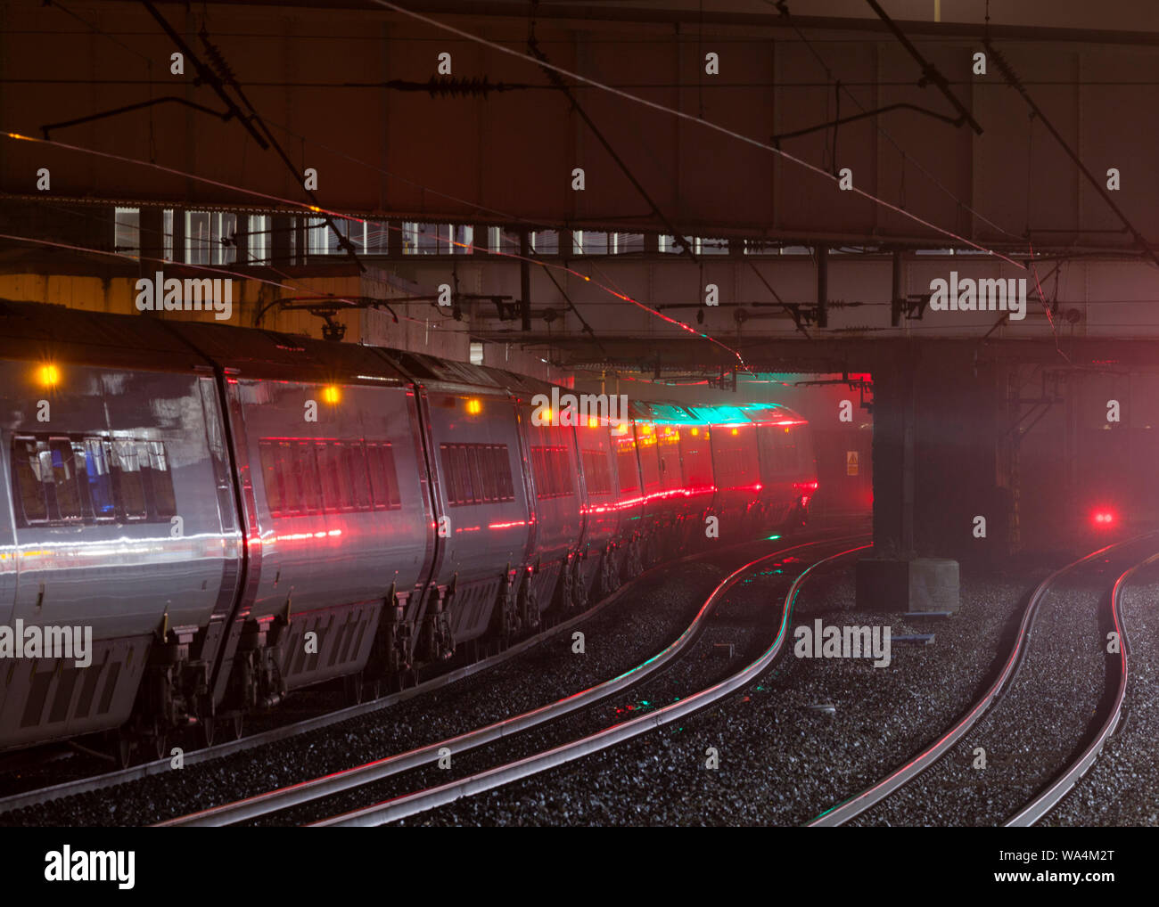 Virgin Trains class 390 pendolino train waiting at a dark misty ...