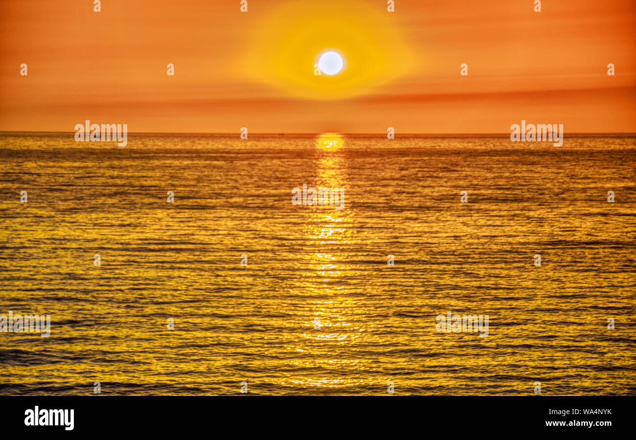 The sunset under the beautiful blue sky on beach Stock Photo - Alamy