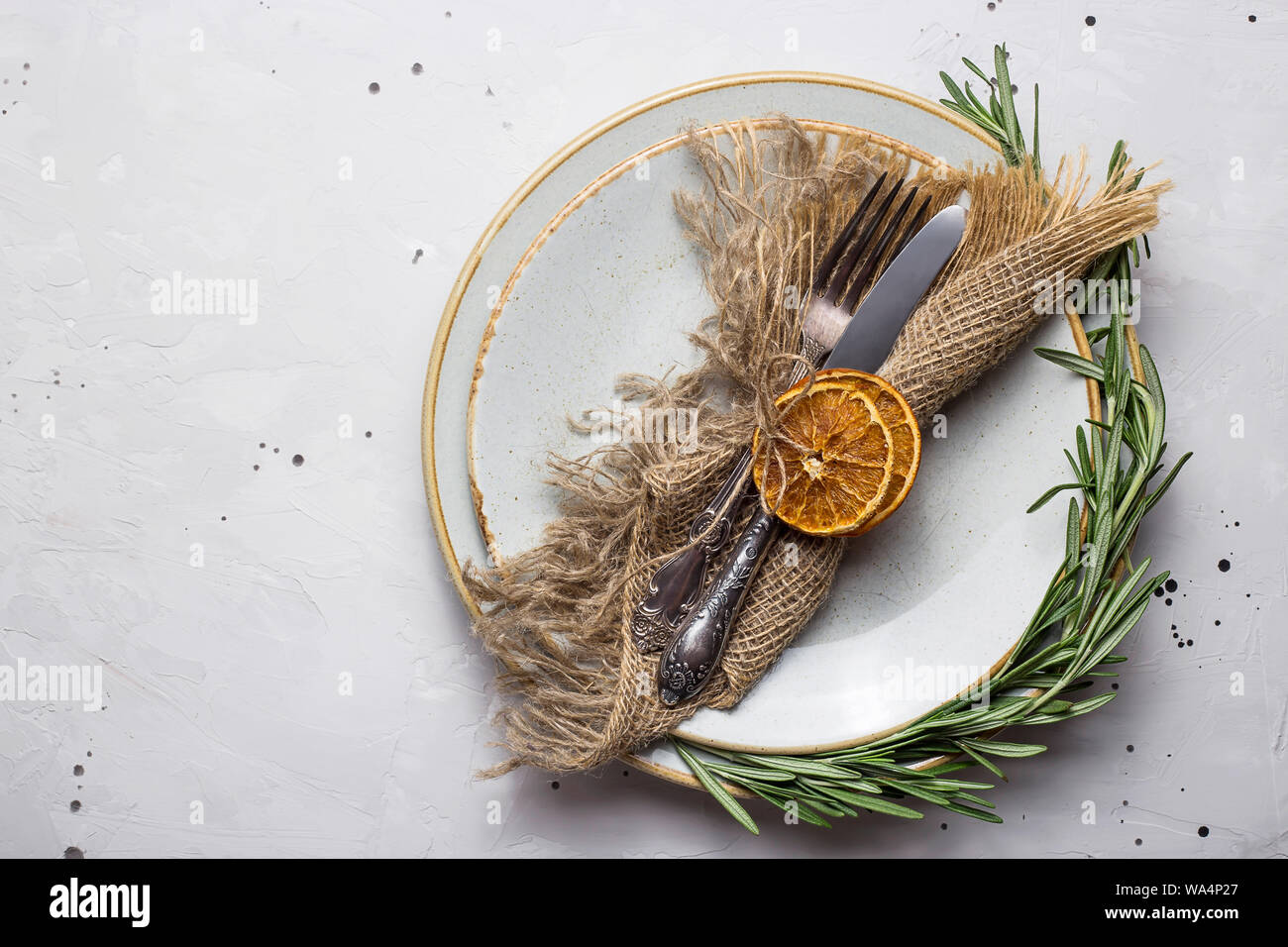 Minimalistic simple rustic table setting with empty plates, fork and ...