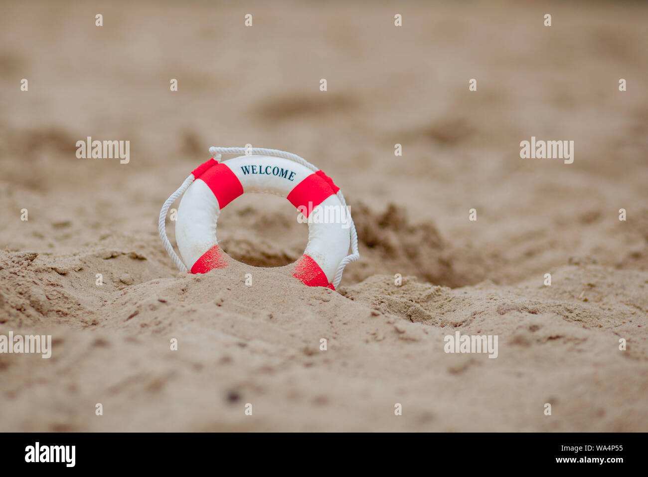 Close-up Of Miniature Lifebuoy Dig In The Sand At Beach Stock Photo - Alamy