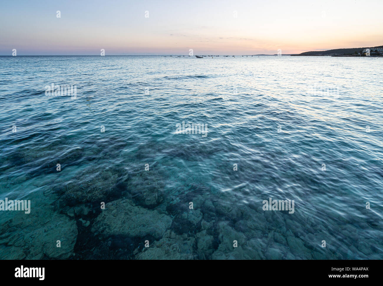 Sunset time in Santo Tomas bay on the island of Menorca Stock Photo - Alamy