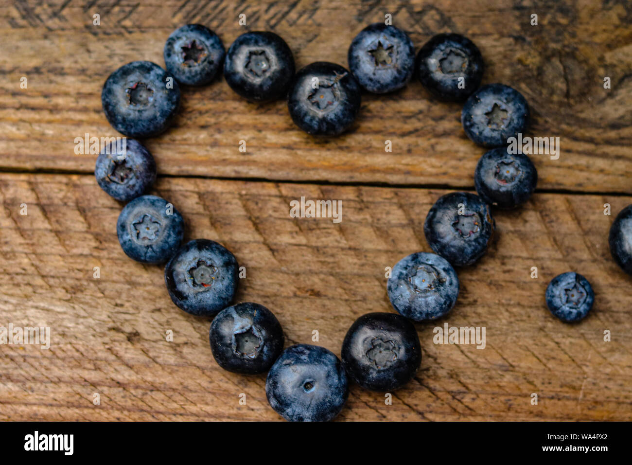 Heart blueberries on wooden hi-res stock photography and images - Alamy
