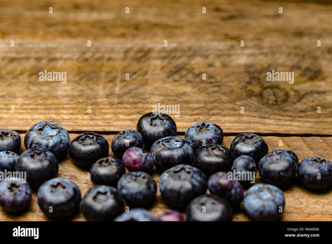 fresh healthy blueberries on a brown wooden table Stock Photo - Alamy