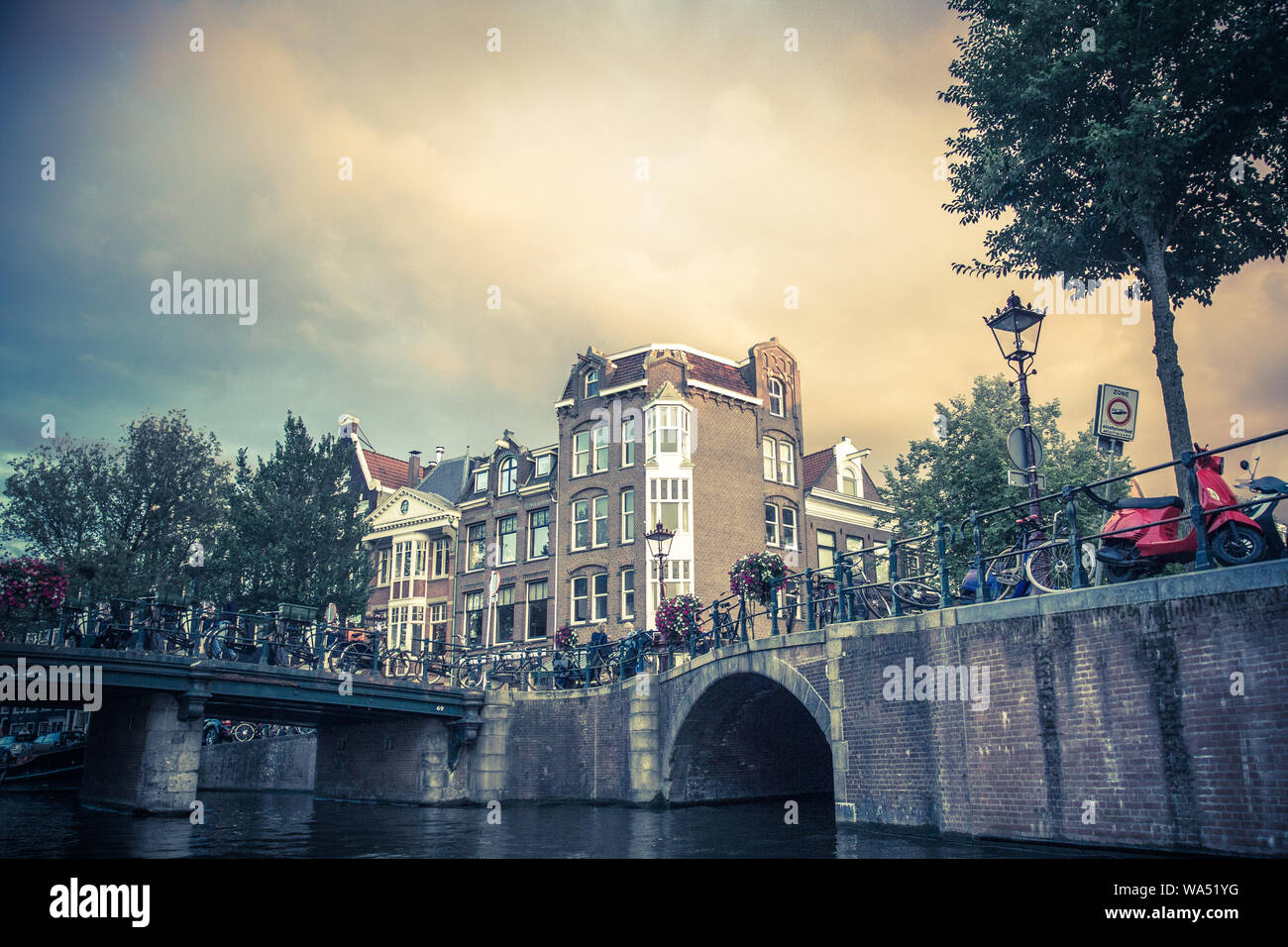 Amsterdam Sunset cityscape with canal, bridge and architecture Stock ...