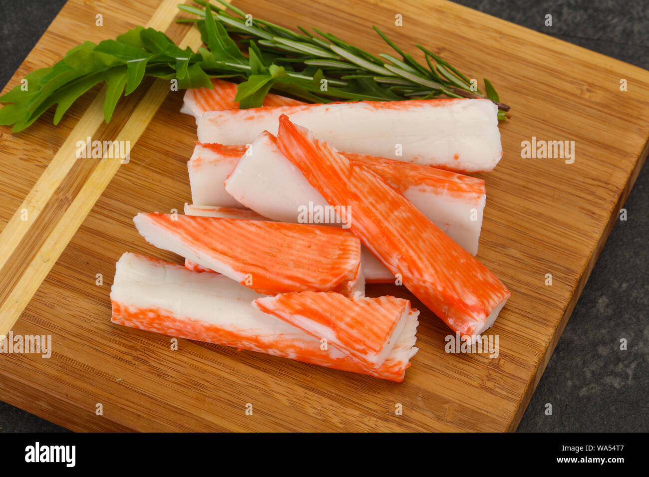 Crab stick surimi over wooden board Stock Photo - Alamy