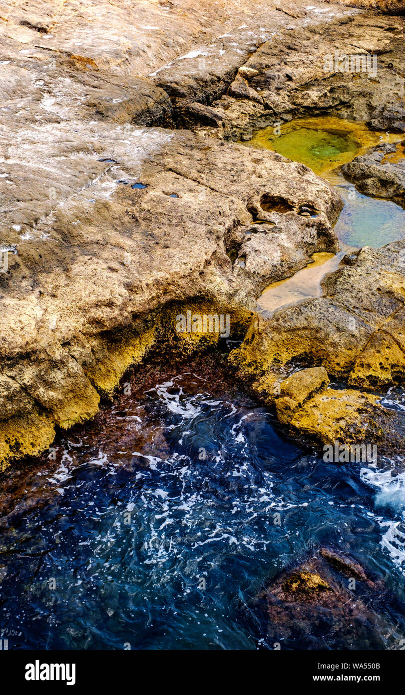 mediterranean waves on rocks of eroded limestone in Malta Stock Photo ...