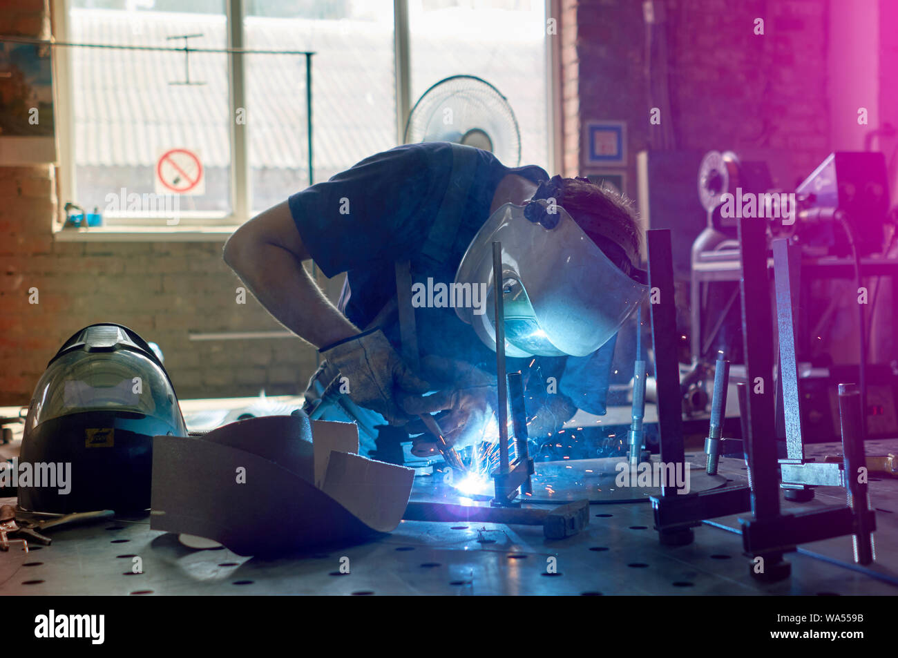welder working with metal in the shop Stock Photo - Alamy