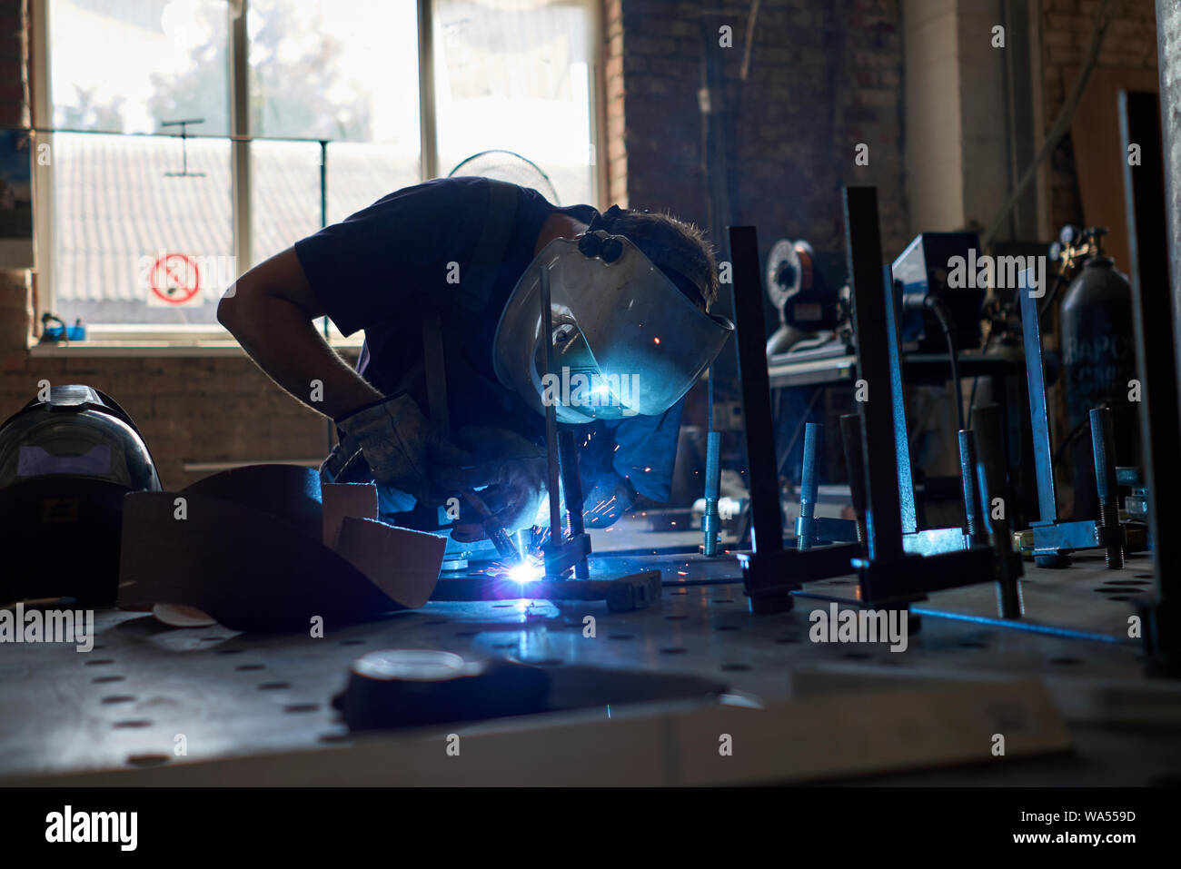 welder working with metal in the shop Stock Photo - Alamy