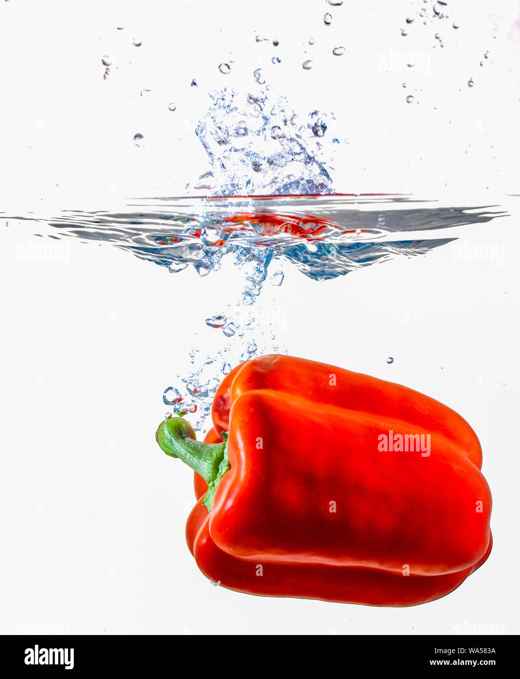 Red Bell Pepper Dropping Into Water making a splash Stock Photo - Alamy