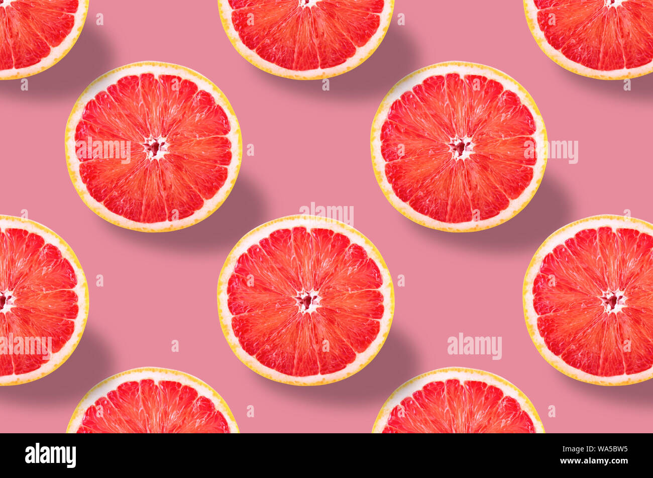 Vivid fruit pattern of fresh grapefruit on colourful background Stock ...