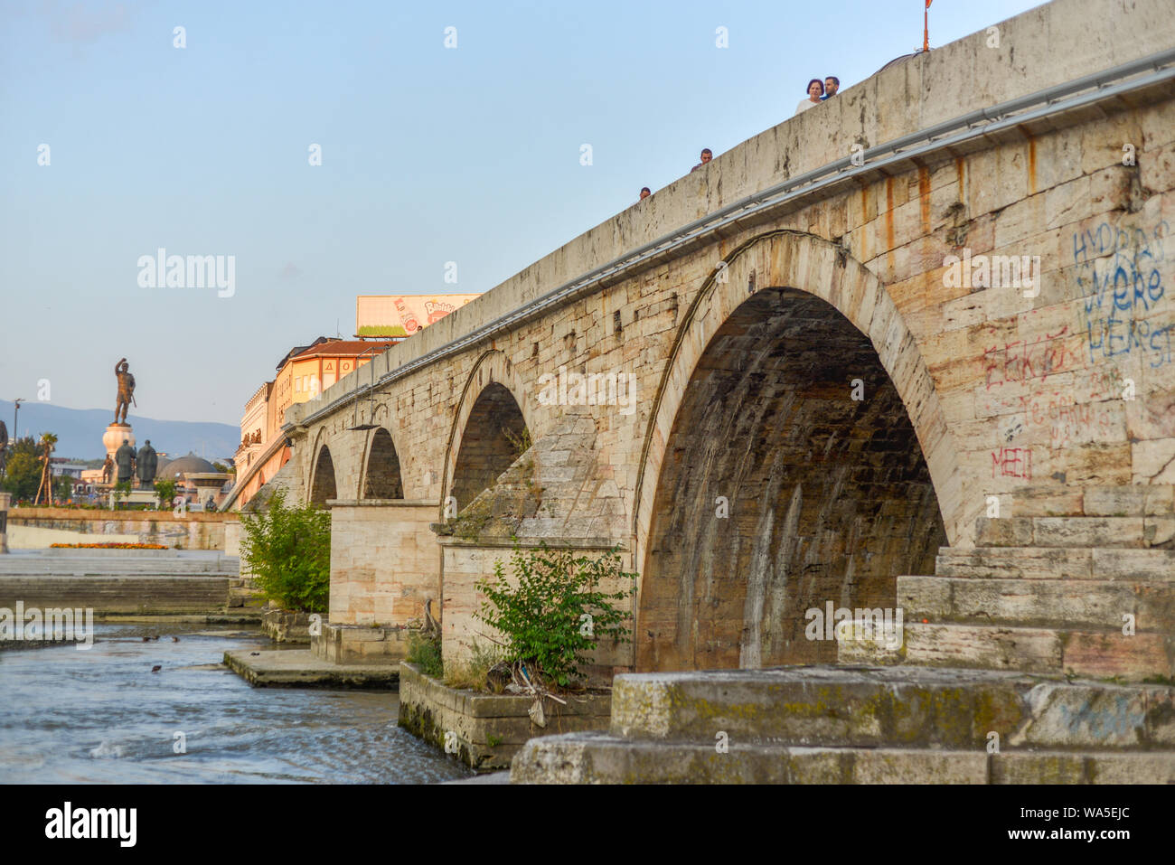 Looking across the Vardar river ,from below the bridge,as the water ...