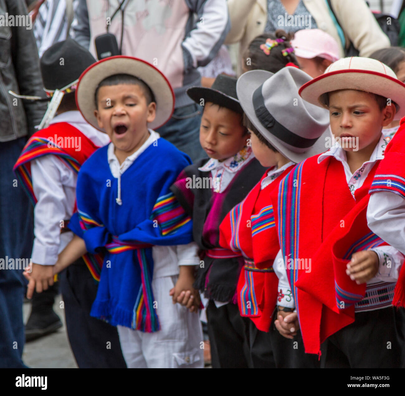 Boy yawns while others look bored during Christmas parade in Cuenca ...
