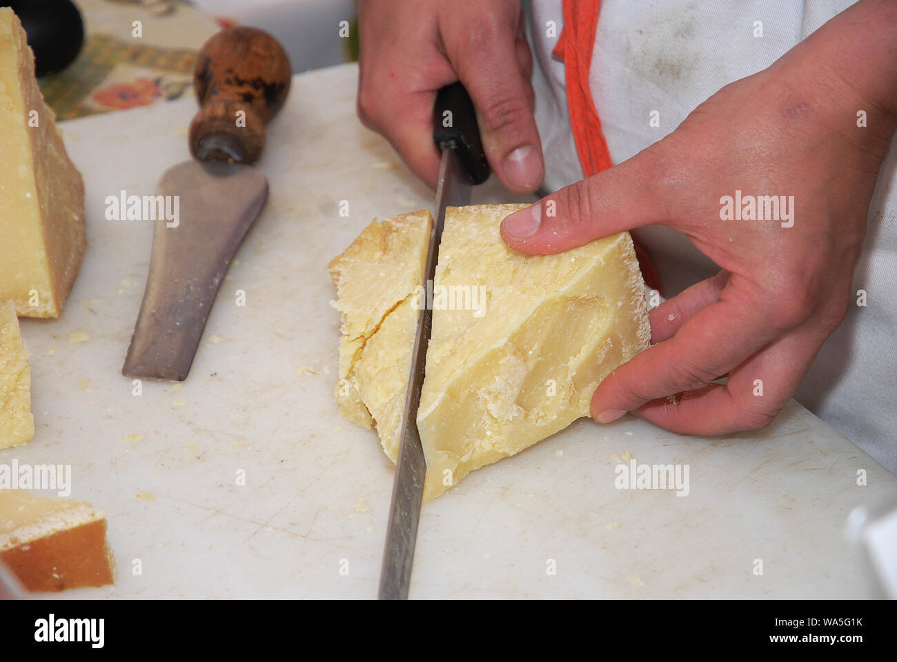 Man cutting parmesan cheese hi-res stock photography and images - Alamy