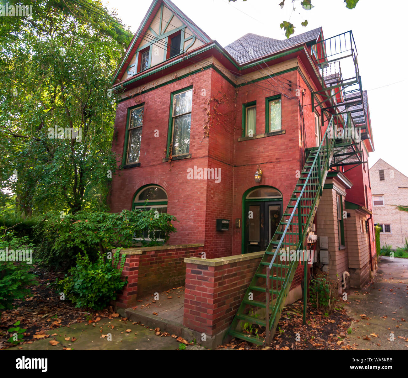 A multi family home built in 1901 with a metal fire escape on the side ...