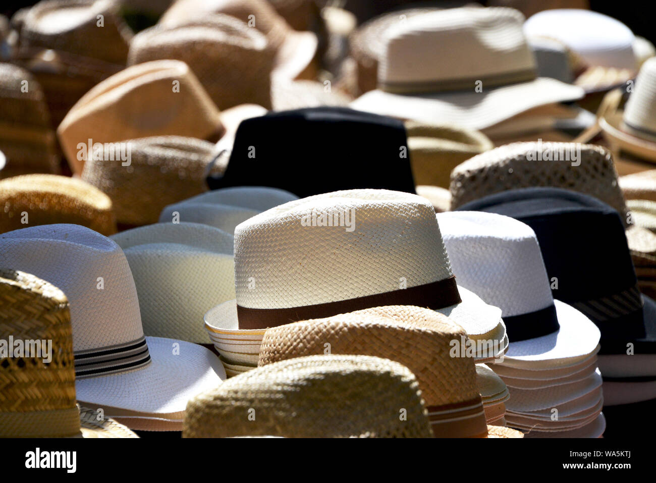straw hats and caps on market Stock Photo - Alamy