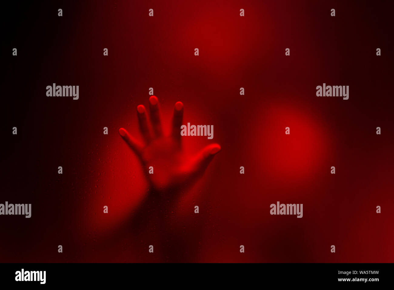 Red color filter version of Creepy man holding the frosted glass with ...