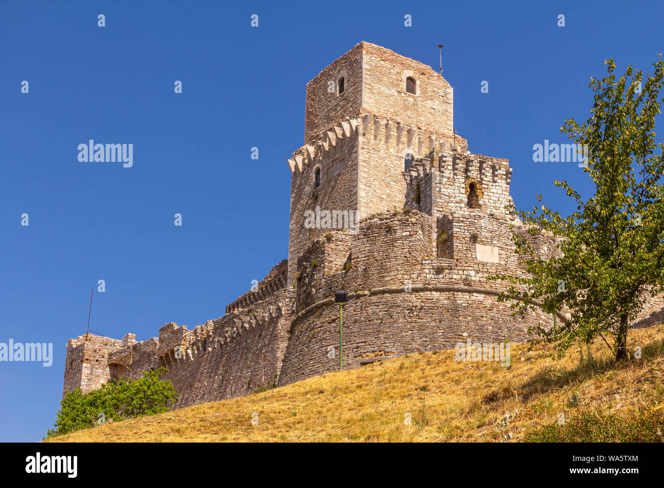 The castle for Rocca Maggiore on a hill above the city of Assisi in ...