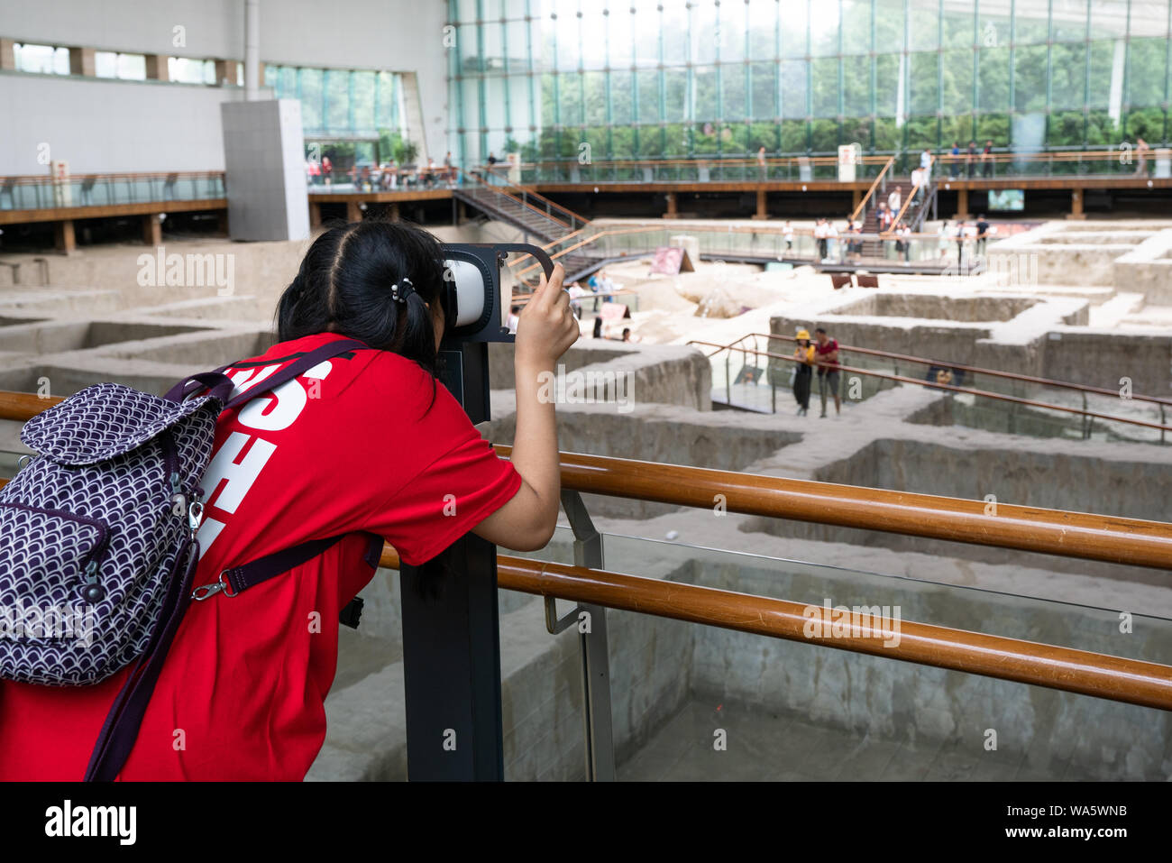 Woman looking through a VR headset at a museum tour display in Chengdu ...