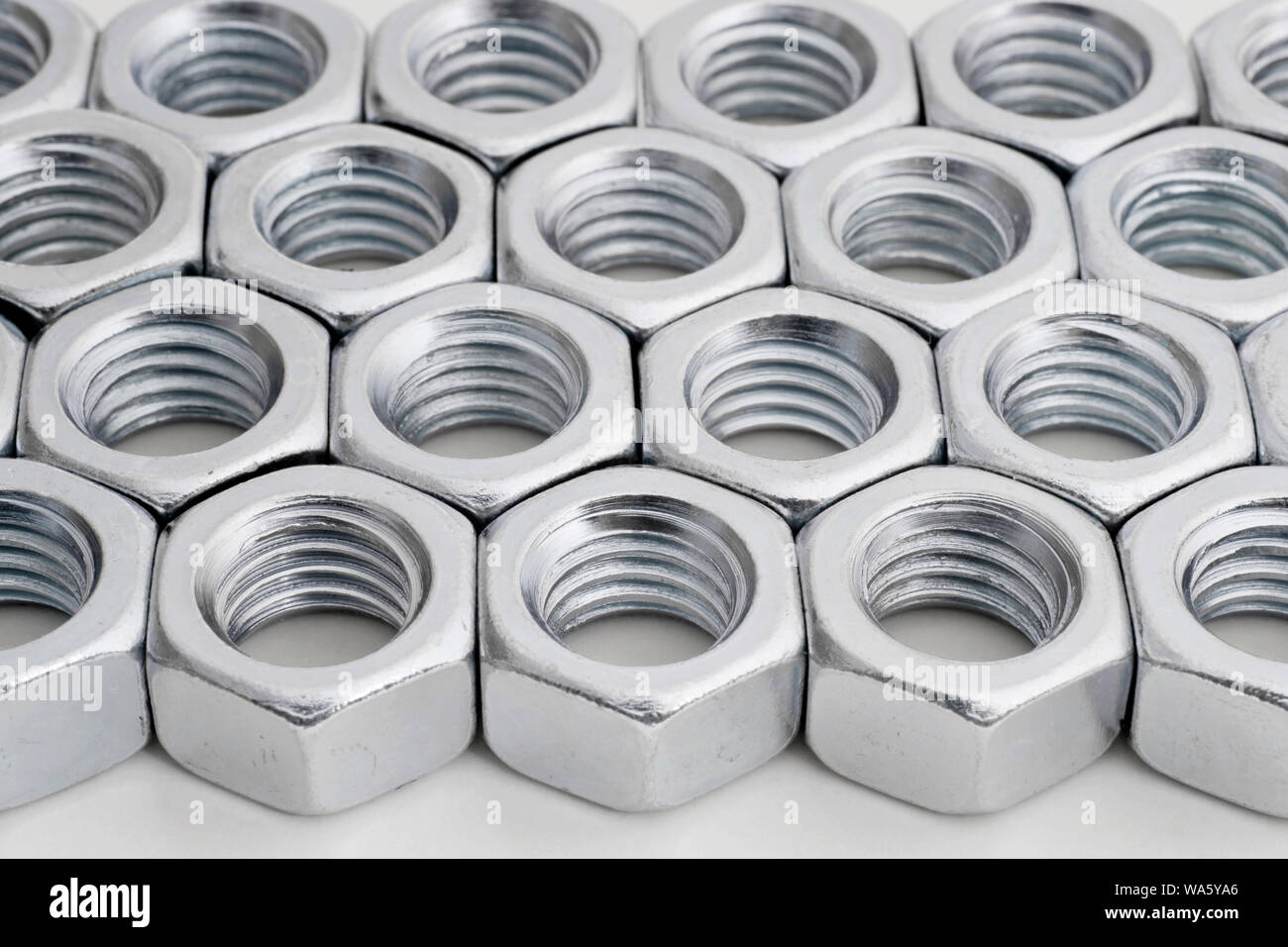 Machine tools - rows of steel nuts, backgrounds Stock Photo - Alamy
