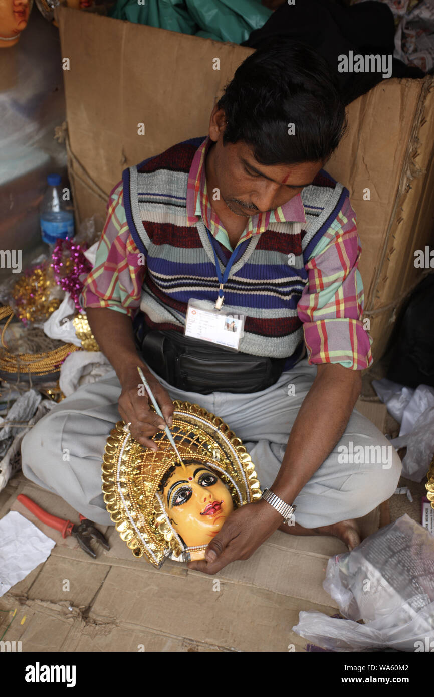 Male artist painting Goddess Durga mask for sale at Surajkund Crafts ...
