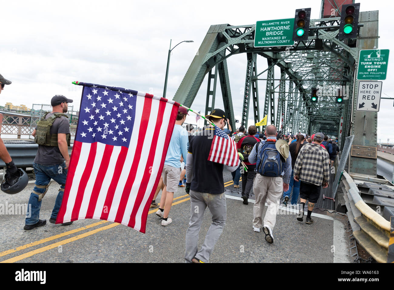 Protesters march across the Hawthorne Bridge during the “End Domestic ...