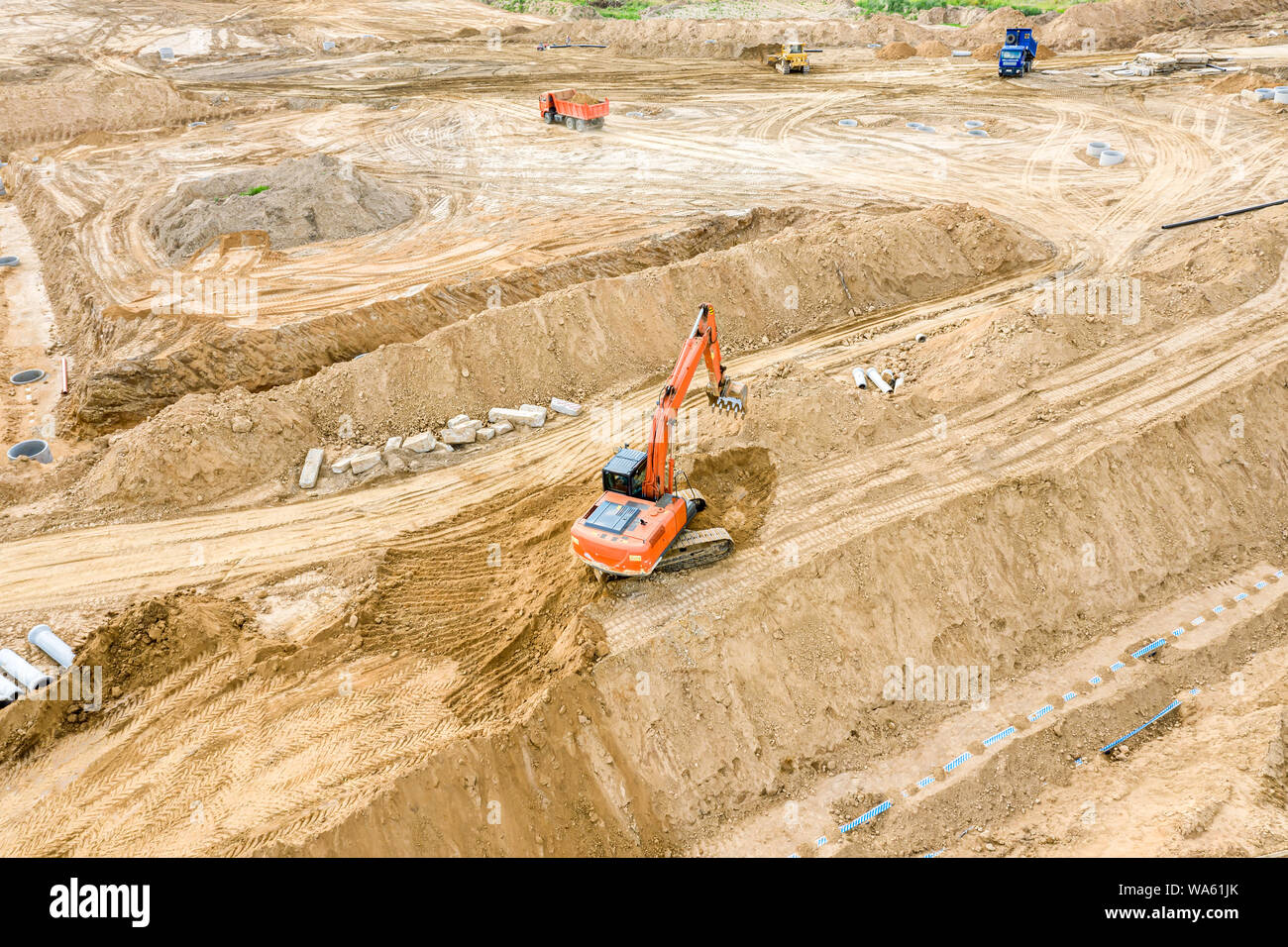 top view of industrial excavator and dump trucks working at ...