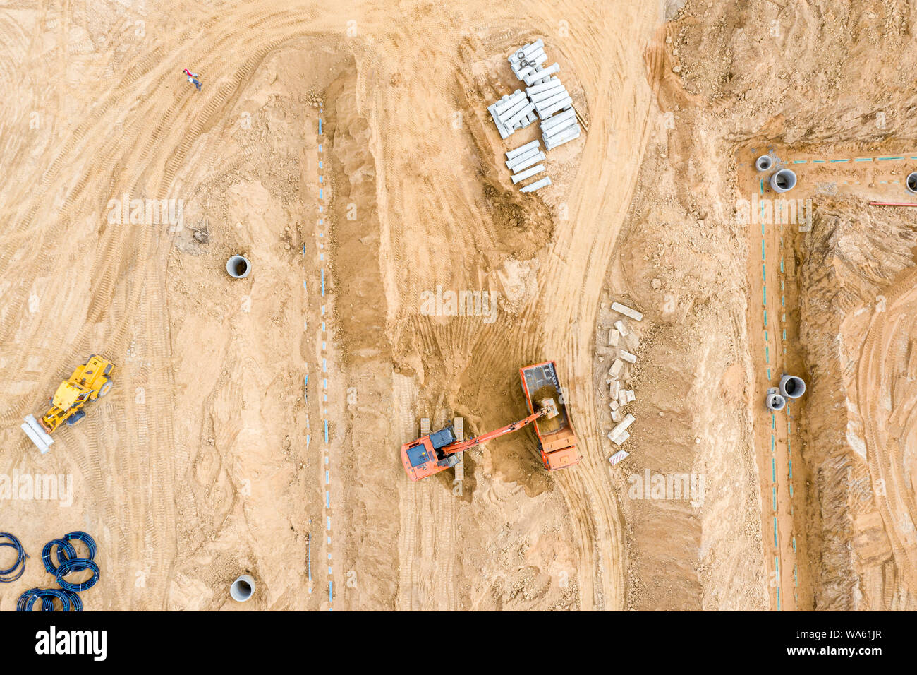 top view of construction site. excavators and dump trucks loading sand ...