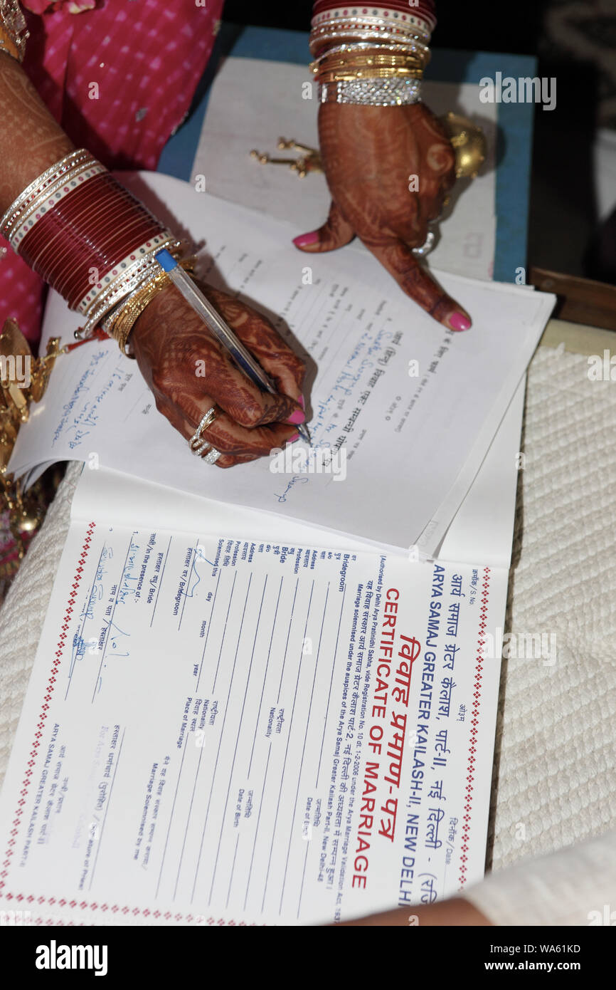 Bride filling marriage certificate form Stock Photo - Alamy