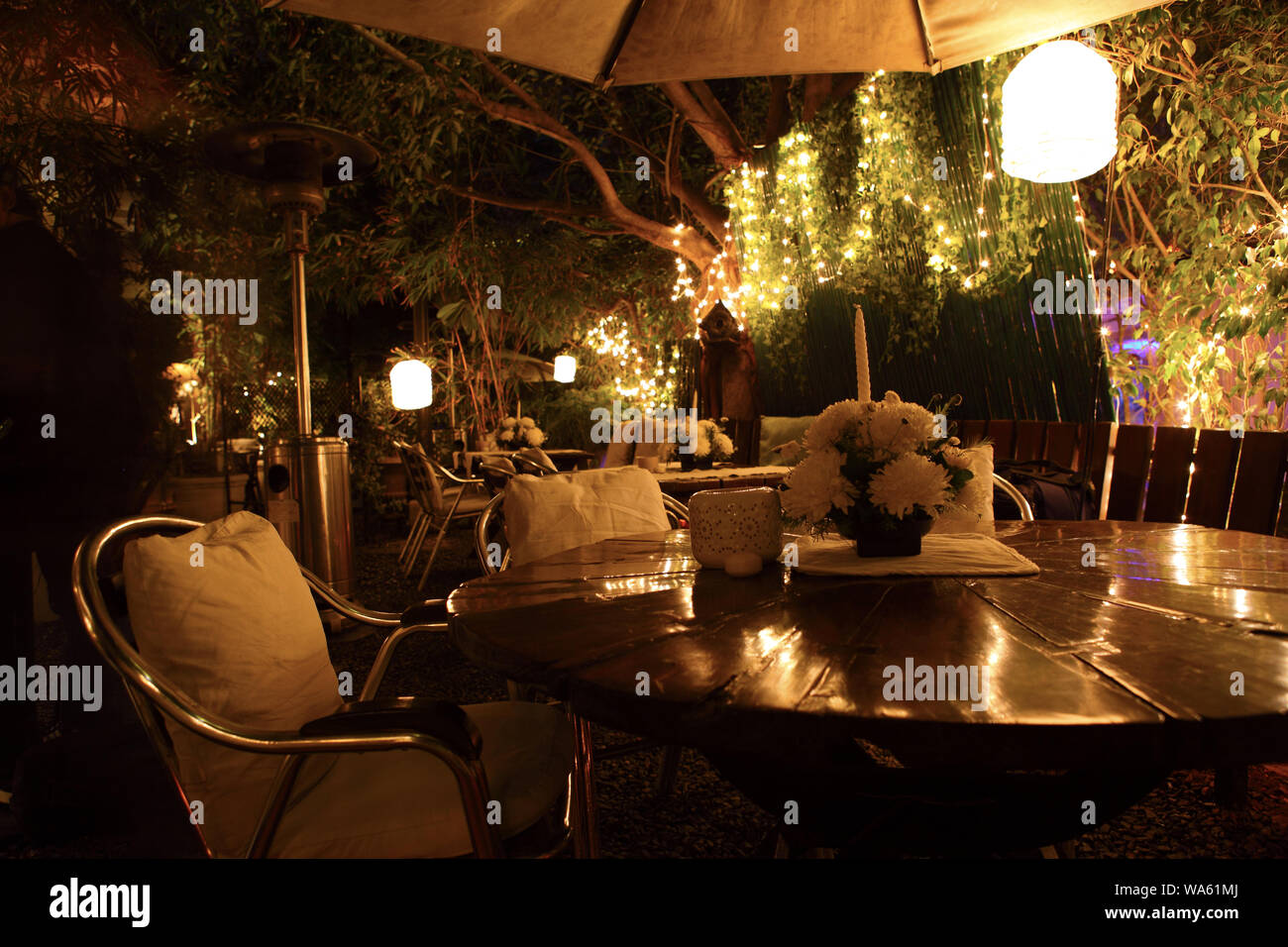 Outdoor scene of table arrangement of a restaurant at night Stock Photo ...