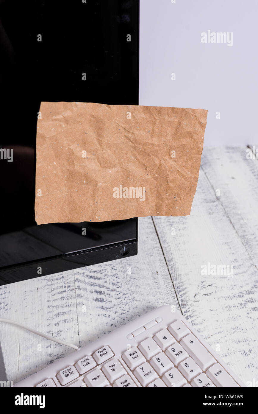 Notation paper taped to black computer monitor screen near white ...