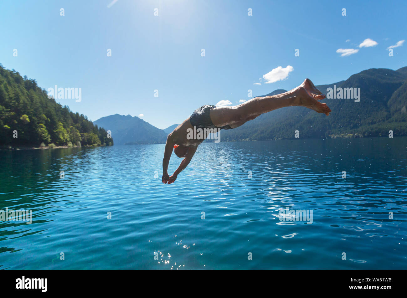 Man jumping into lake hi-res stock photography and images - Alamy