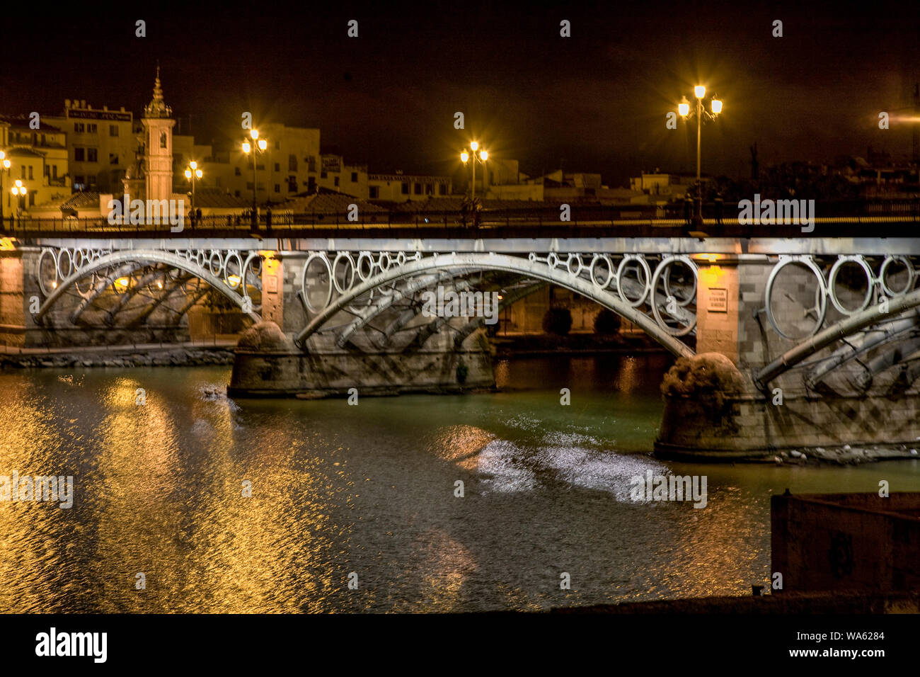 Bridge in Sevilla, Spain at night river Stock Photo - Alamy