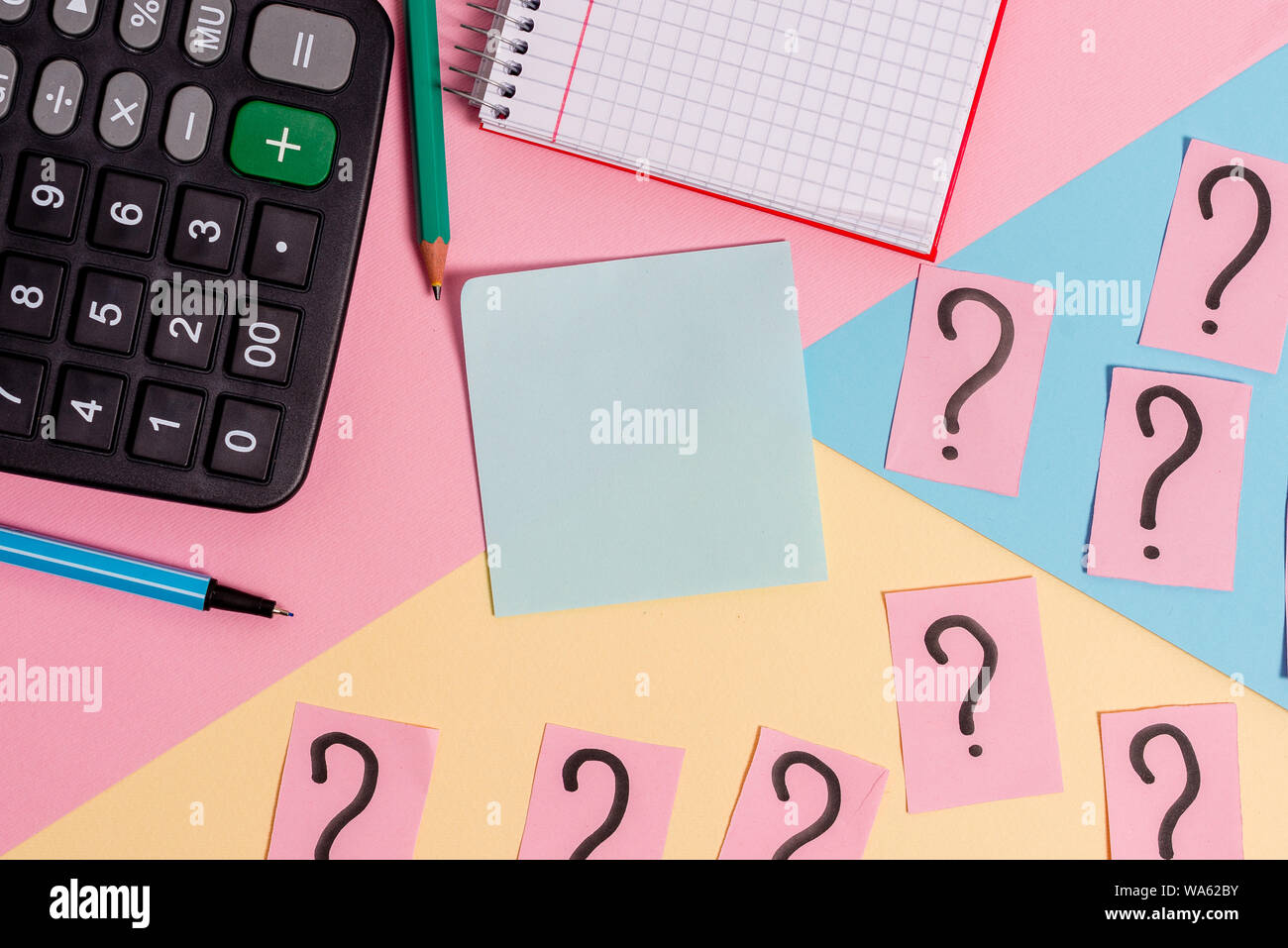 Mathematics stuff and writing equipment above pastel colours background ...
