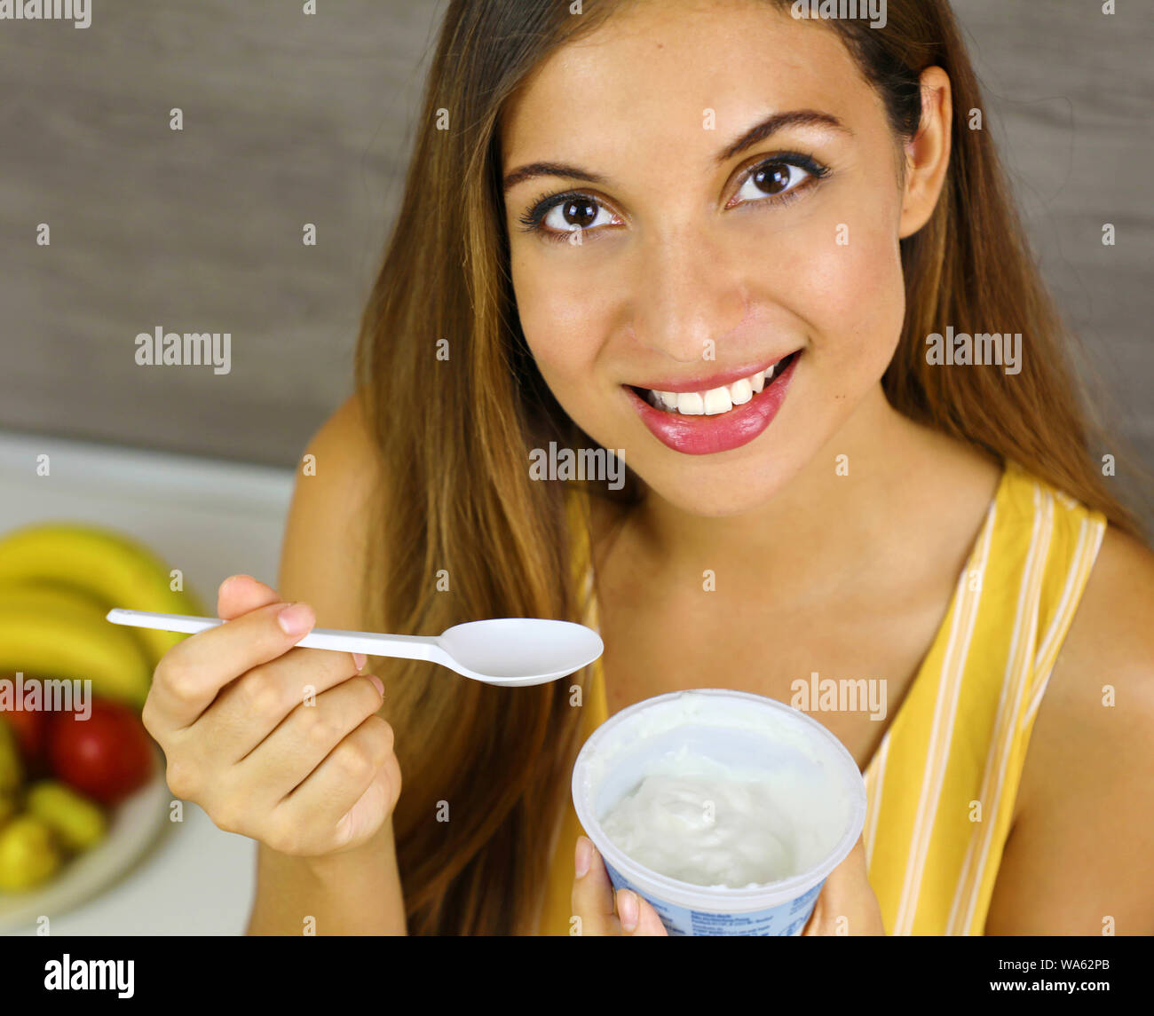 Woman eating yoghurt nuts hi-res stock photography and images - Alamy
