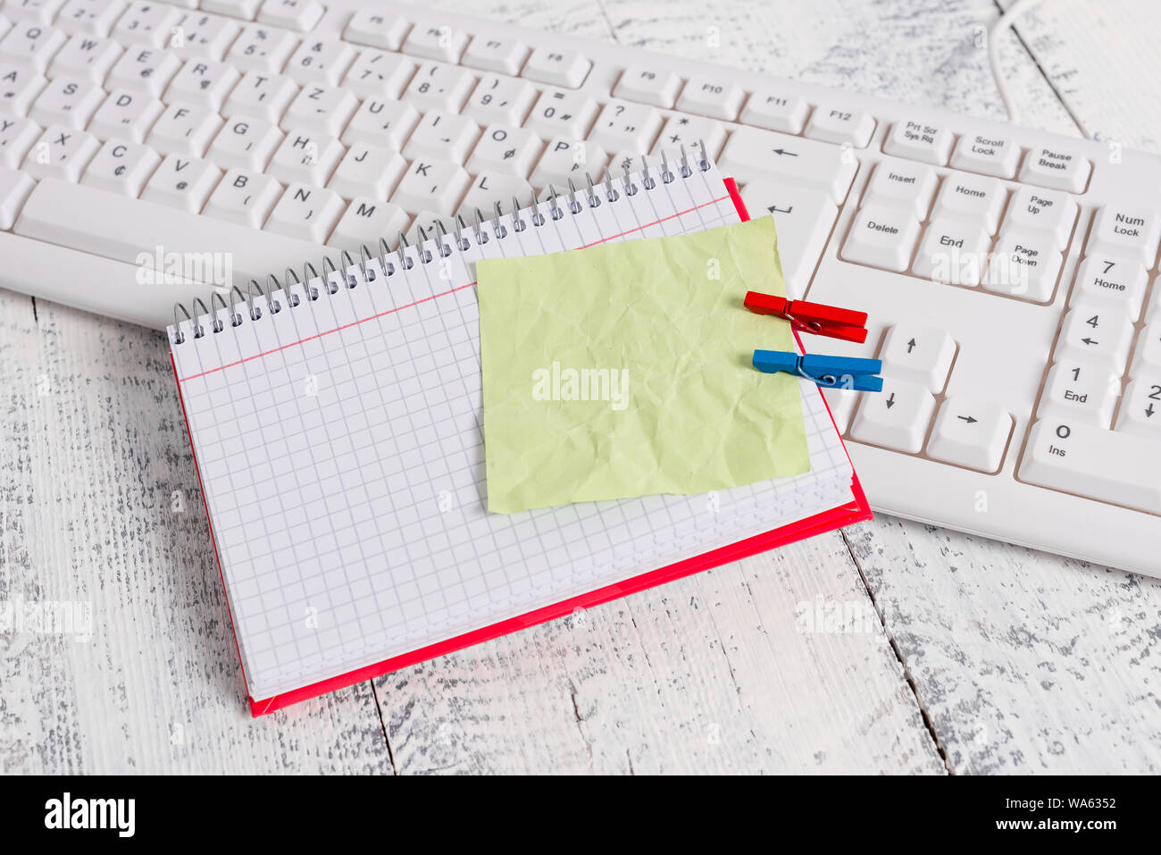 notebook paper reminder clothespin pinned sheet white keyboard light ...