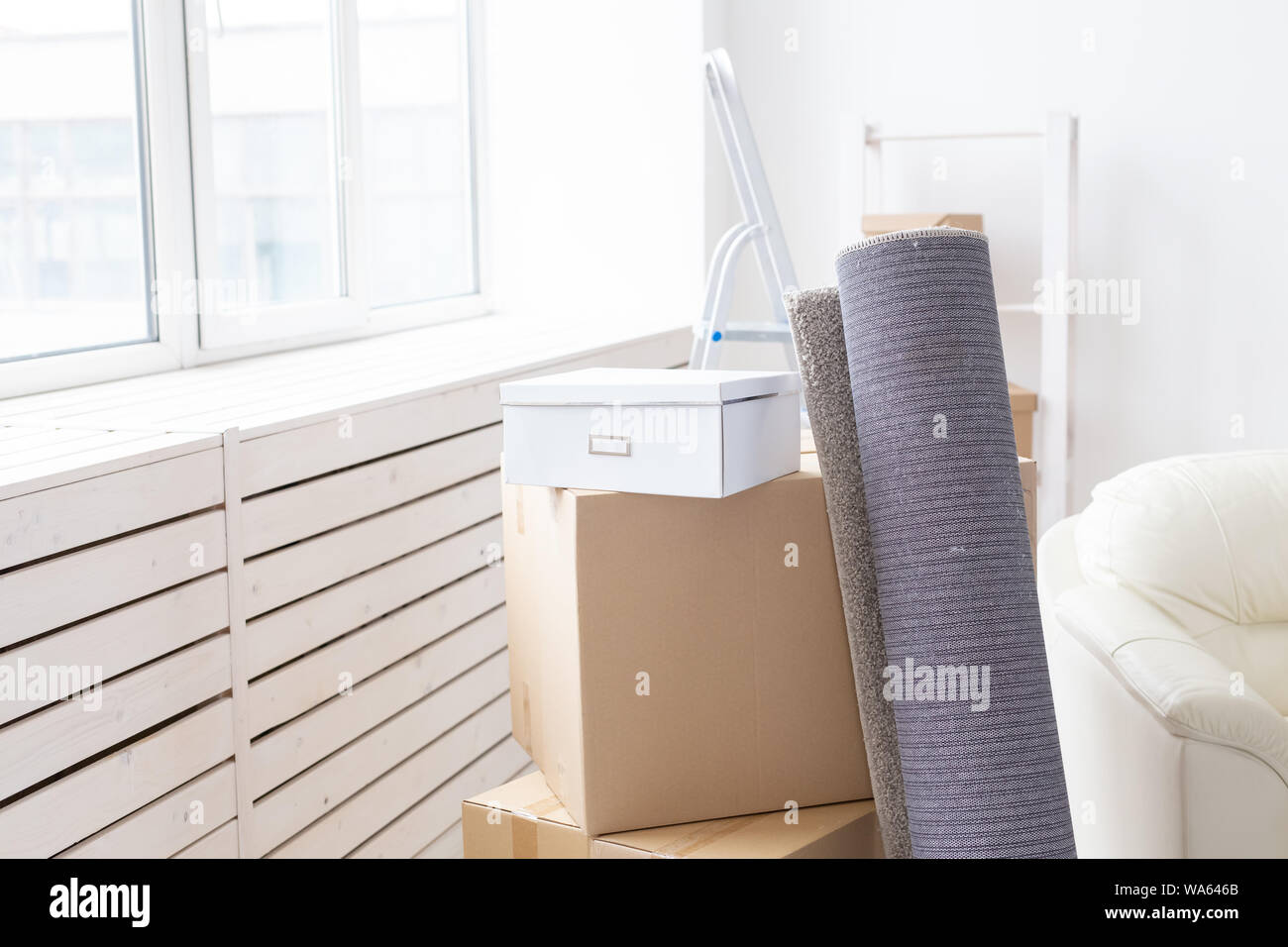 Cardboard boxes and carpet - moving to a new house Stock Photo - Alamy