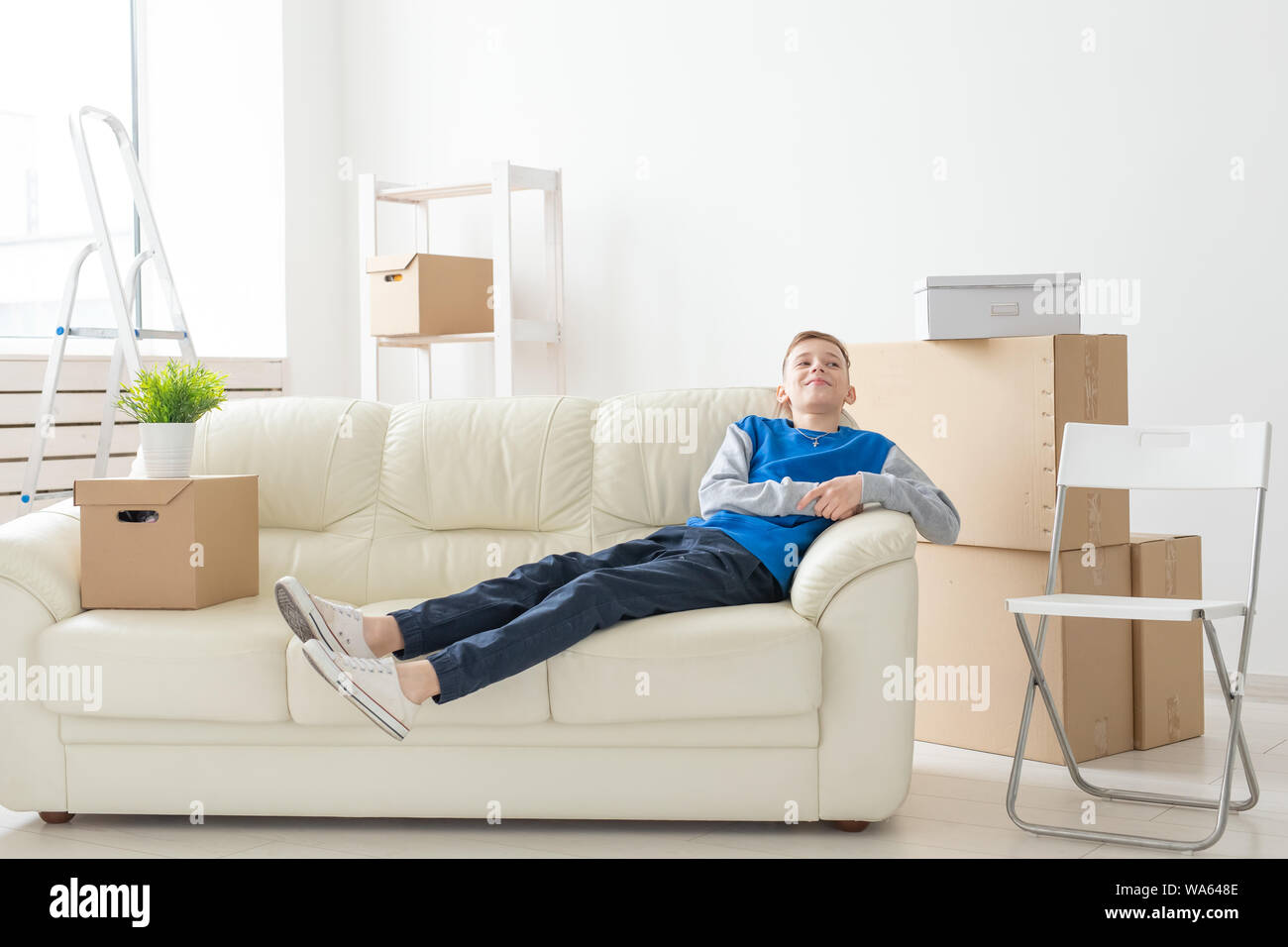 Relocation, new house and children concept - Satisfied happy teen boy ...