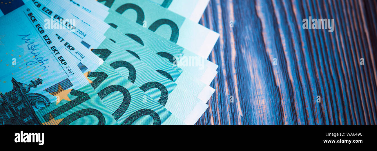Euro banknotes in fan at wooden background Stock Photo - Alamy