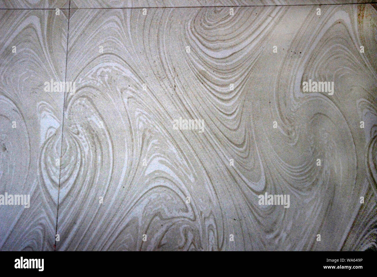 Close-up of marble stone flooring with beautiful, flowing, curly grain ...