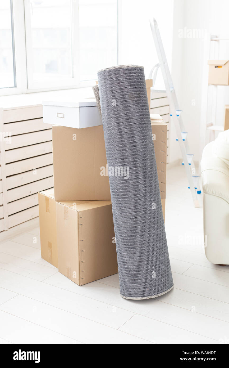Cardboard boxes, sofa and carpet - moving to a new house Stock Photo ...