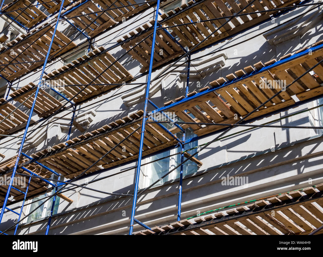 Fragment of scaffolding on the facade of the building Stock Photo - Alamy