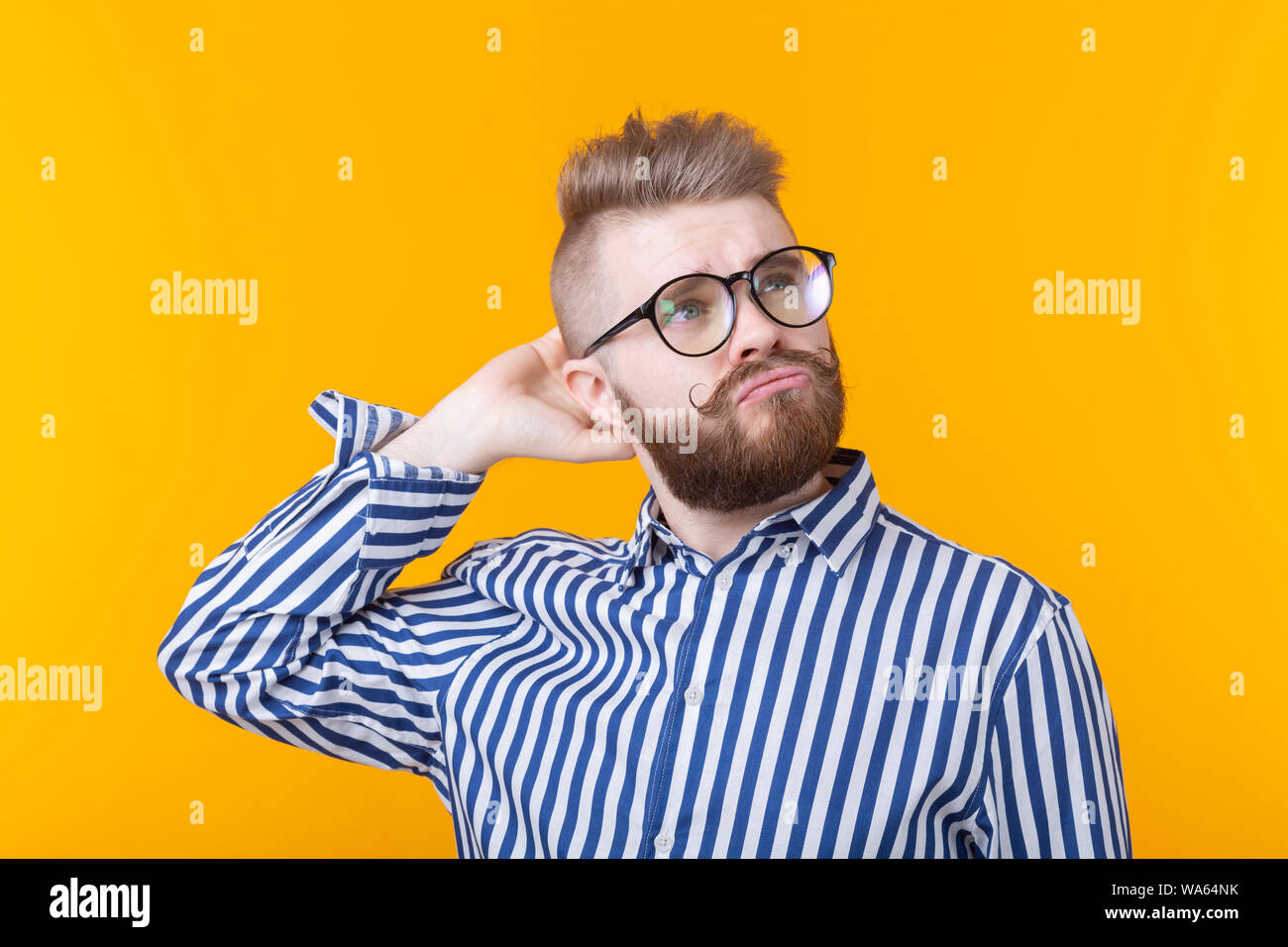 Portrait of a positive young male student with a stylish hairstyle with ...