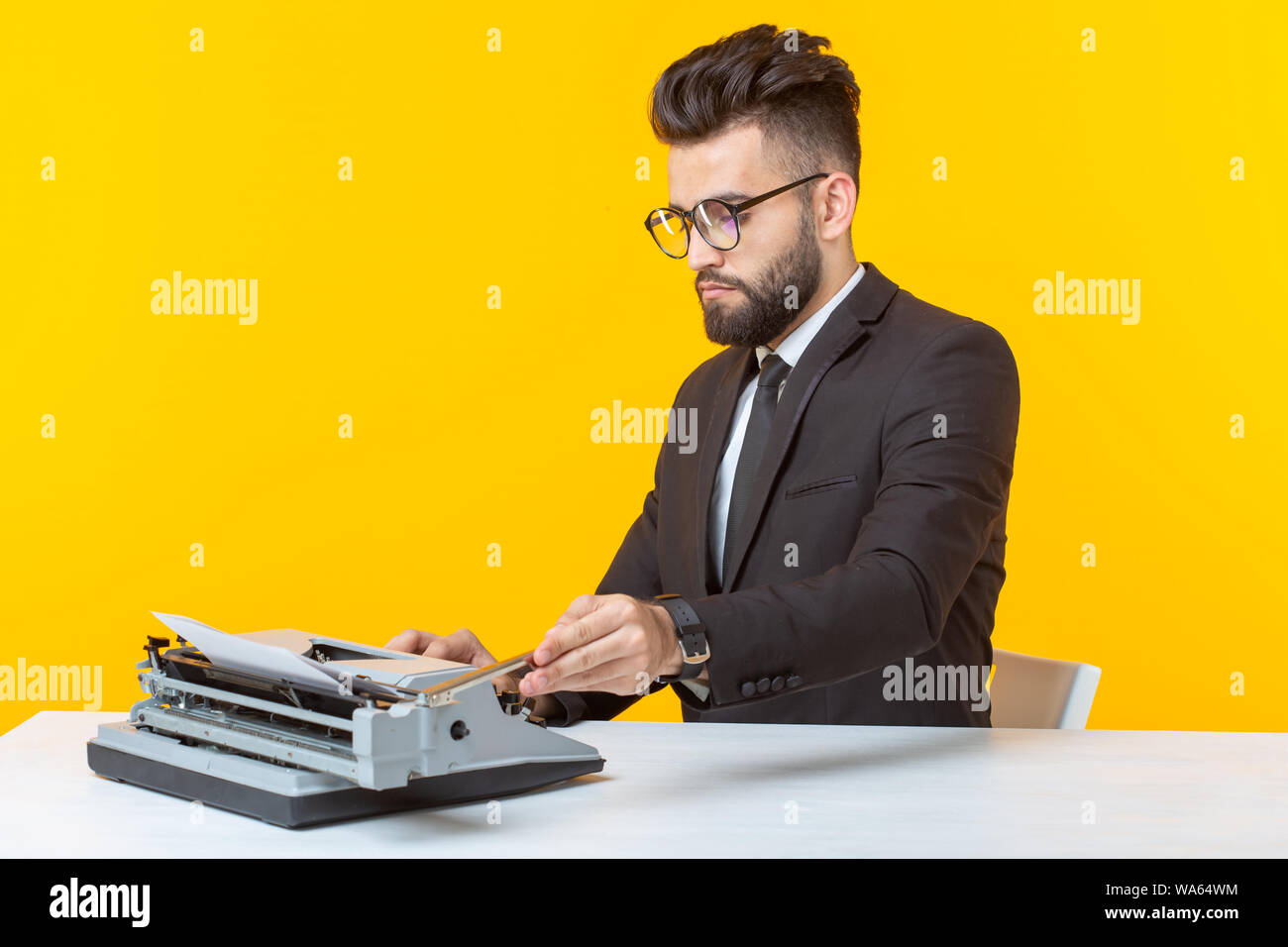 Young handsome male businessman in formal clothes typing text on a ...