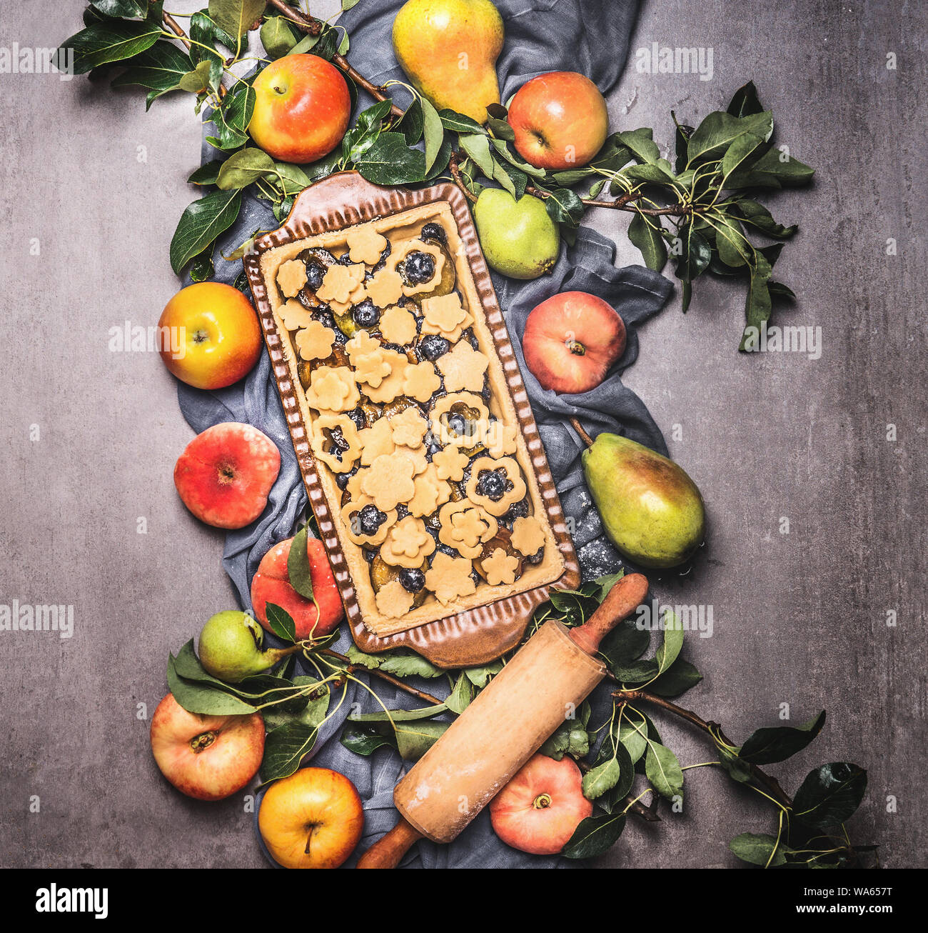 Preparation of open fruits pie with organic ingredients from garden ...