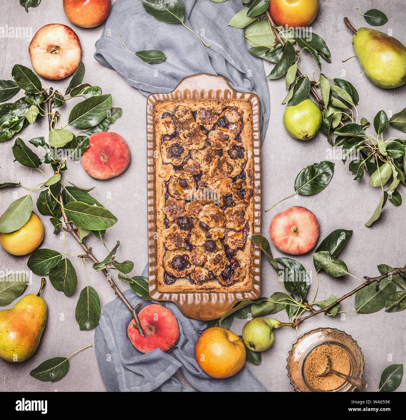 Seasonal baking. Open fruits pie with organic ingredients from garden ...
